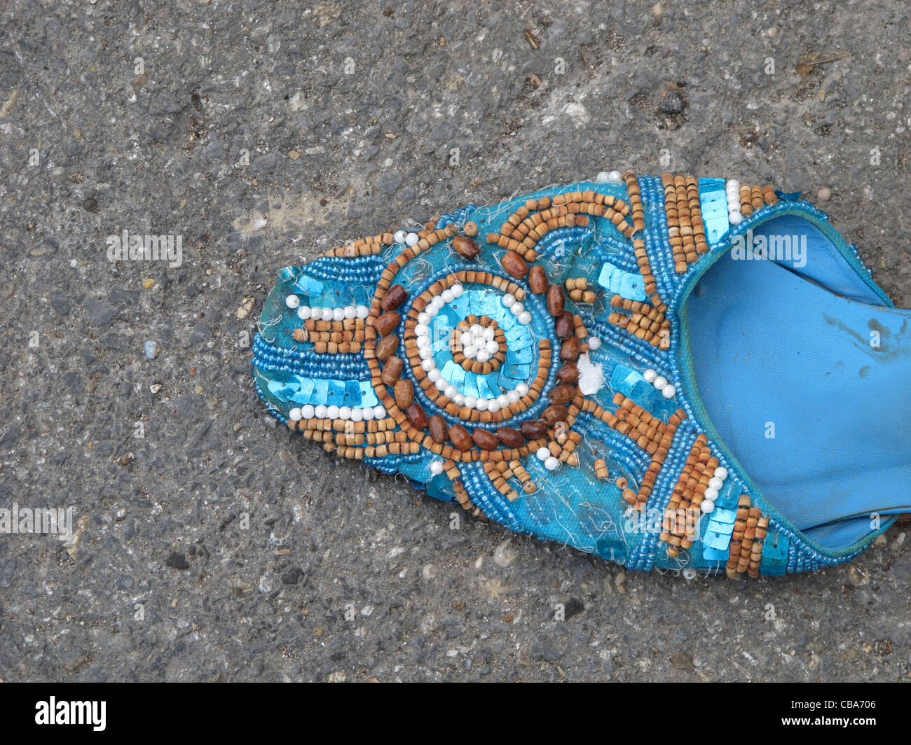 Blue slipper shoe on street road Stock Photo - Alamy