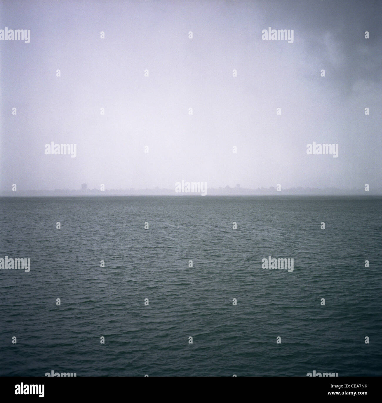 Faint glimmer of land on the horizon, viewed from ship at sea Stock ...