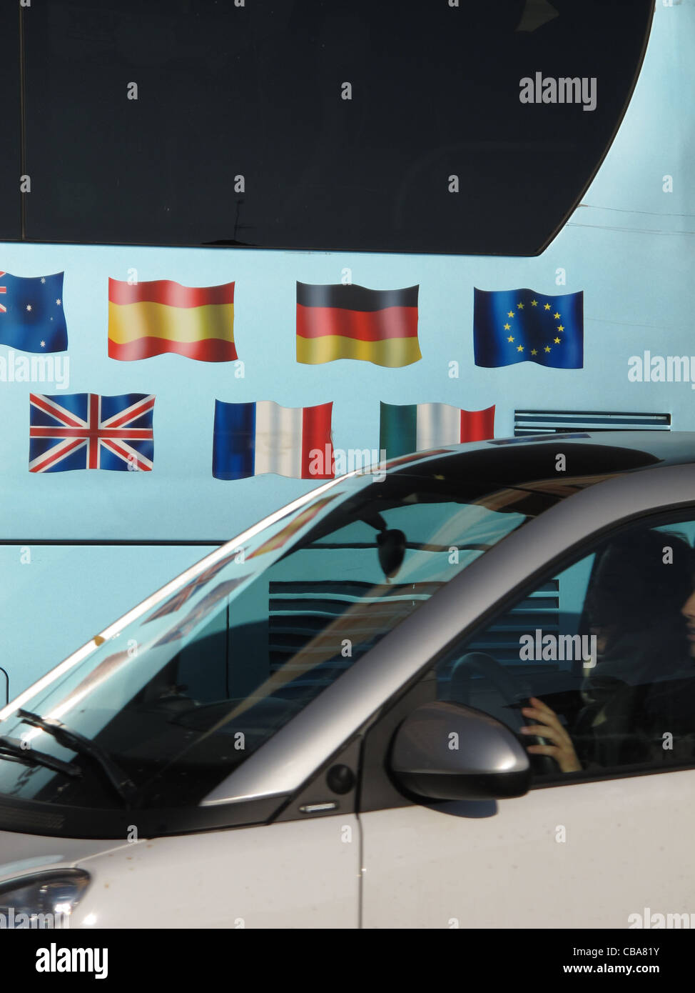 international and european union flags on side on bus coach in city ...