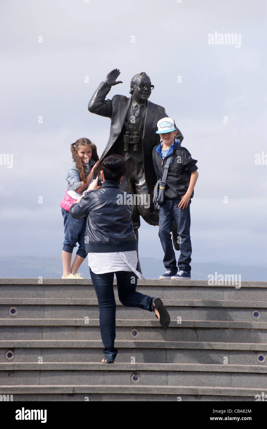 A family taking a photograph at the statue of comedian Eric Morecambe ...