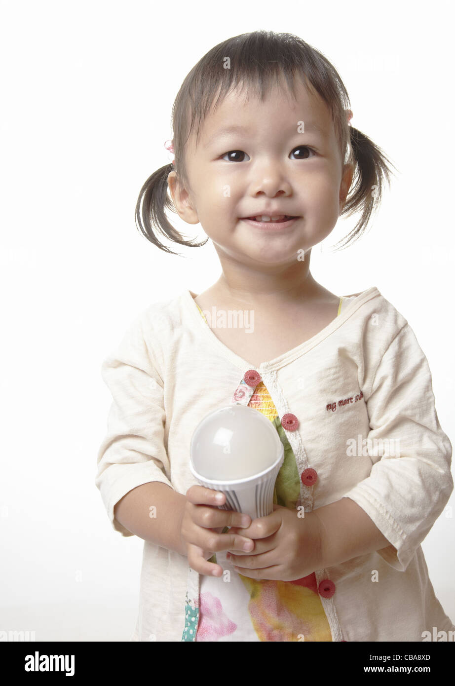 Girl holding a LED bulb Stock Photo - Alamy