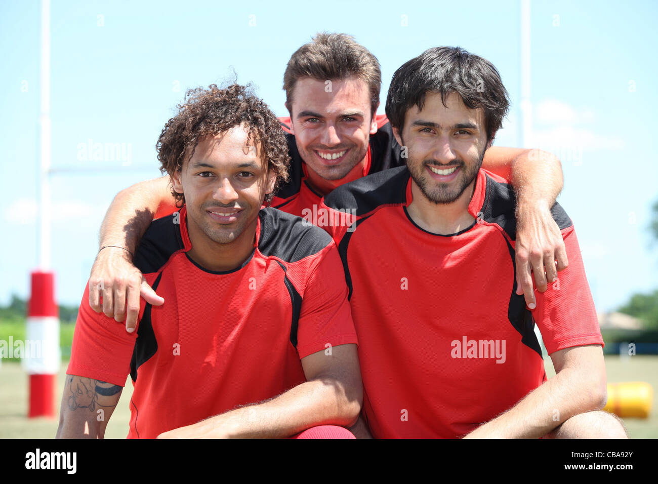 Three friendly young rugby players Stock Photo - Alamy