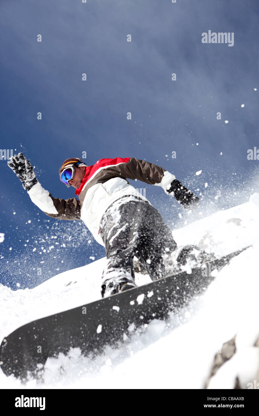 Snowboarder spraying powder Stock Photo - Alamy