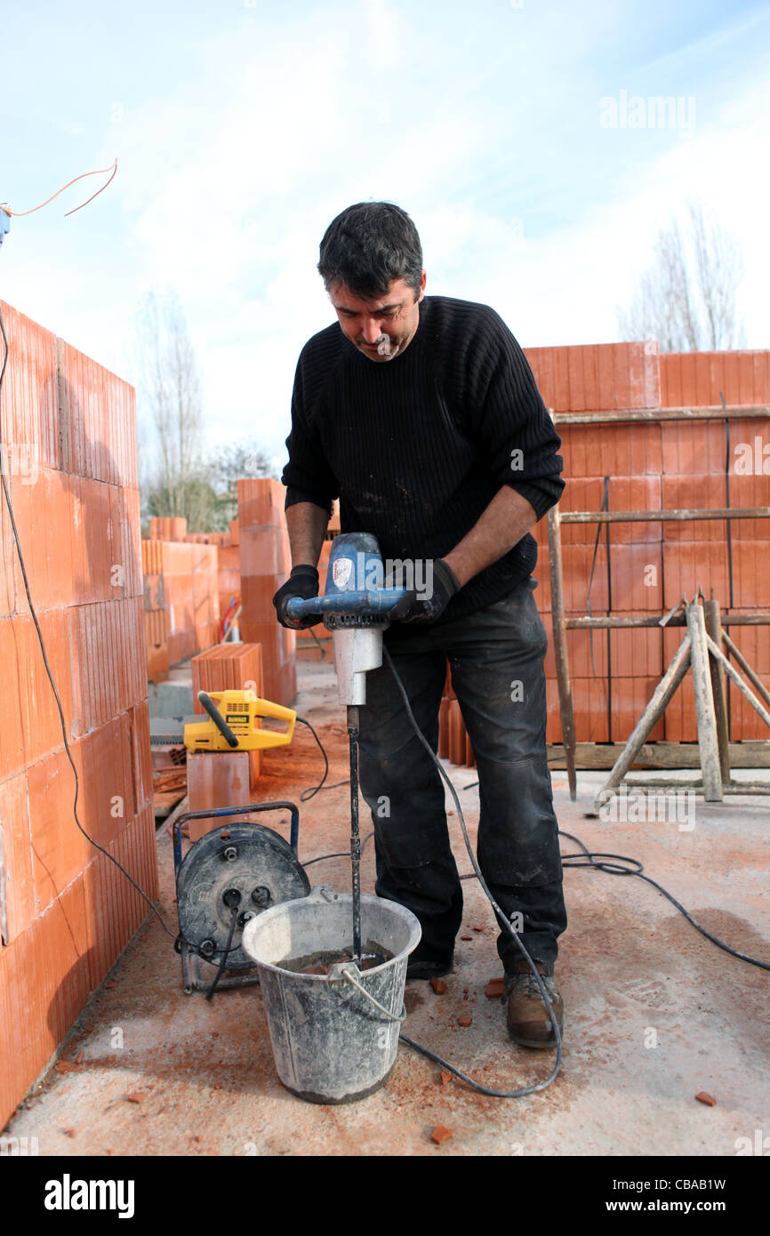 Man mixing cement Stock Photo - Alamy