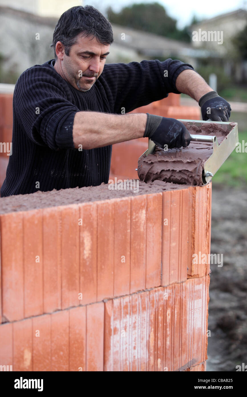 Construction worker carefully installing hi-res stock photography and ...