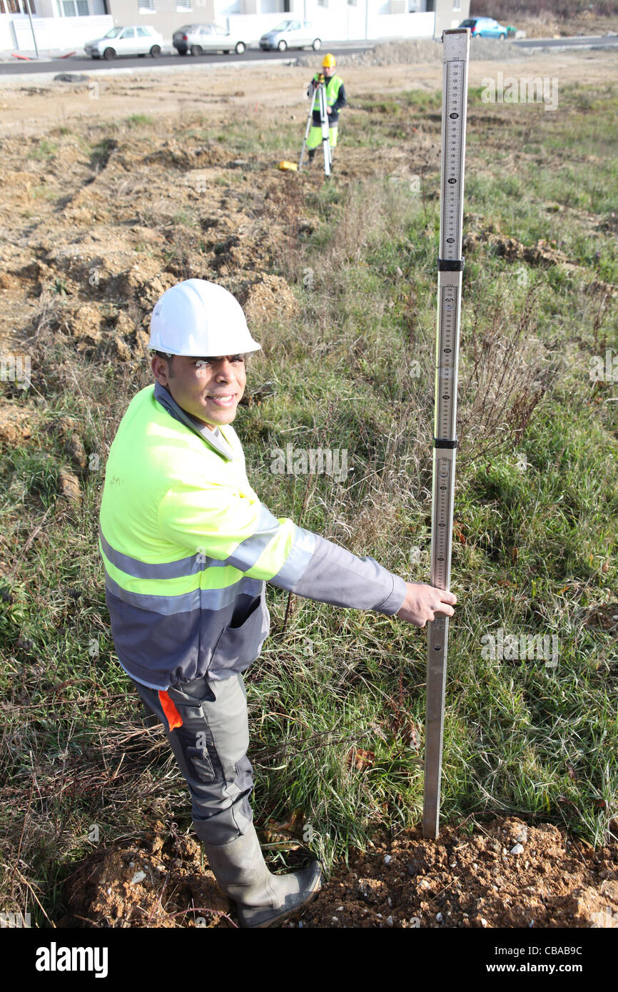 Two surveyors in field Stock Photo - Alamy
