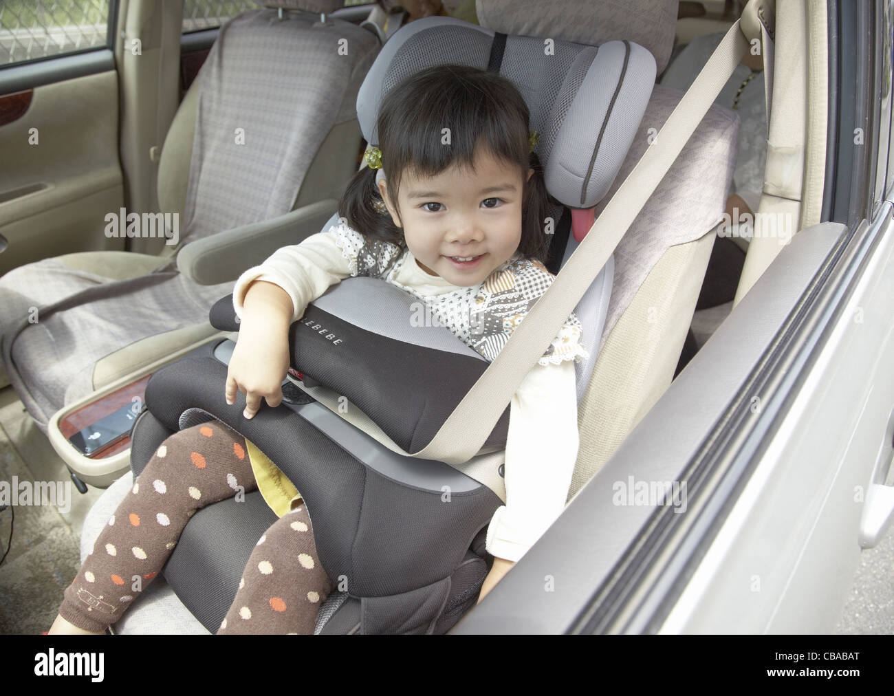 Girl sitting in car seat Stock Photo - Alamy