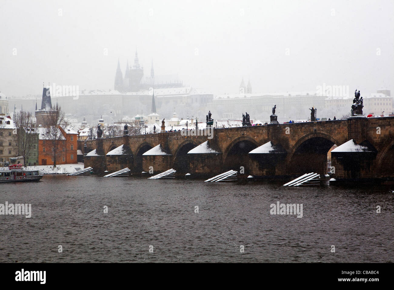 View on snow covered Charles Bridge in Prague, Czech Republic on Nov ...