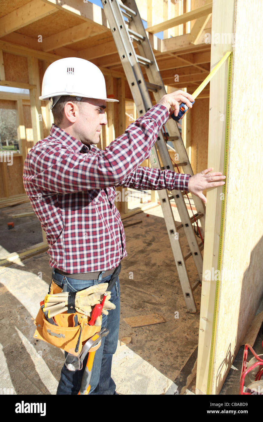 Carpenter working on house Stock Photo - Alamy