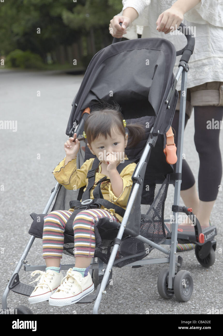 Girl in stroller Stock Photo - Alamy
