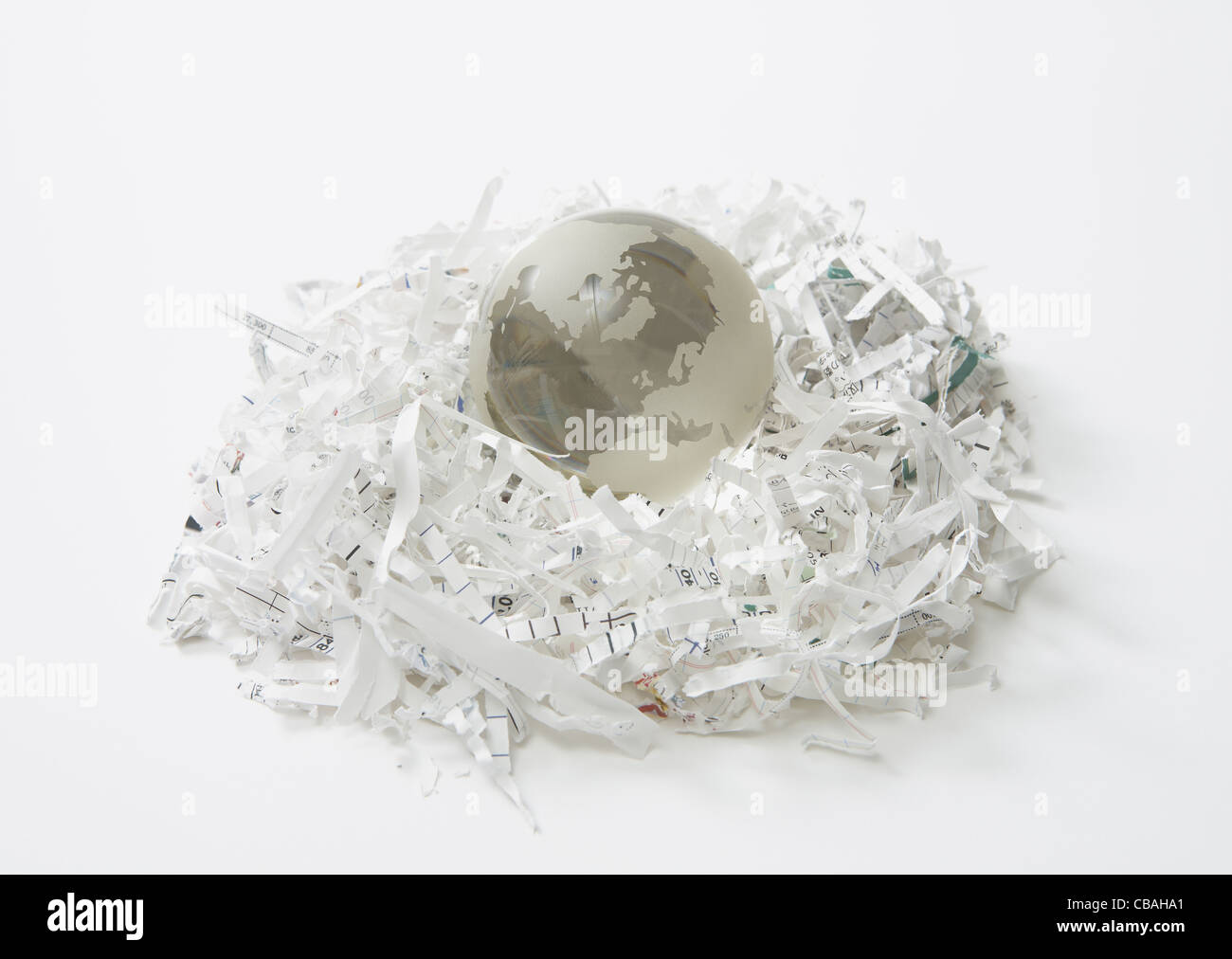 Globe buried in shredder dust Stock Photo - Alamy