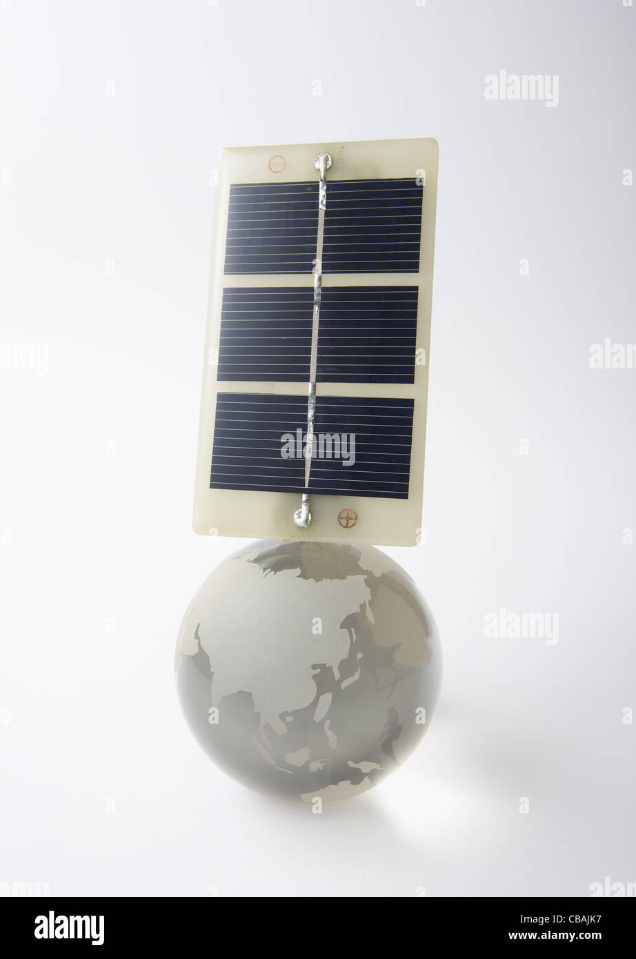 Globe and solar panels Stock Photo - Alamy