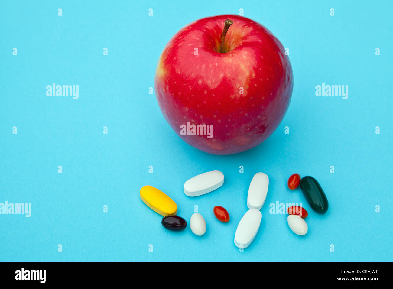 Ripe red apple next to tablets Stock Photo - Alamy
