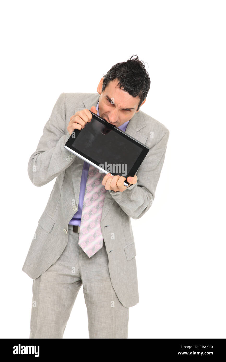 young business man standing biting a tablet isolated on white ...