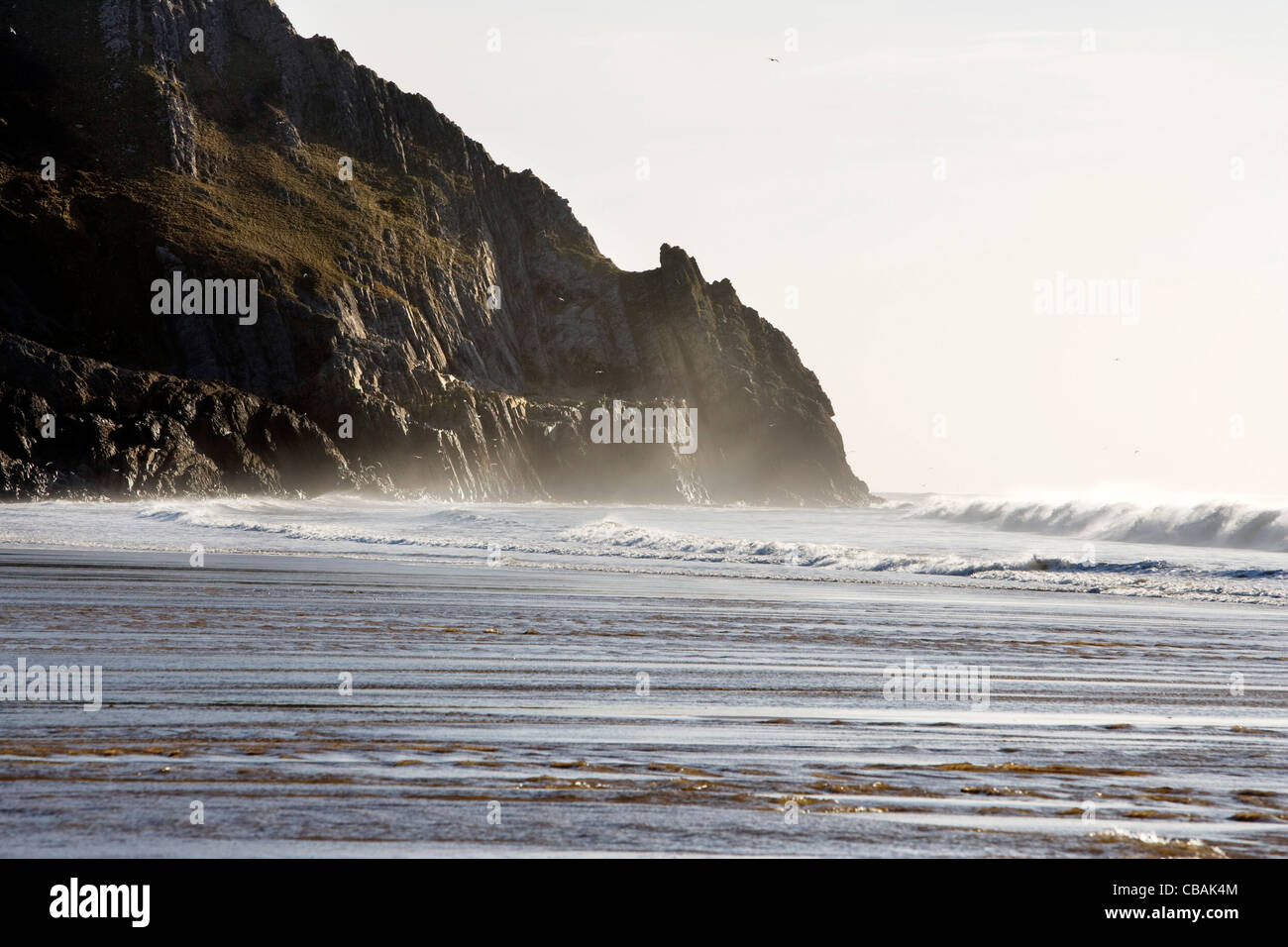 Waves crashing into Cliff face Wales Stock Photo - Alamy