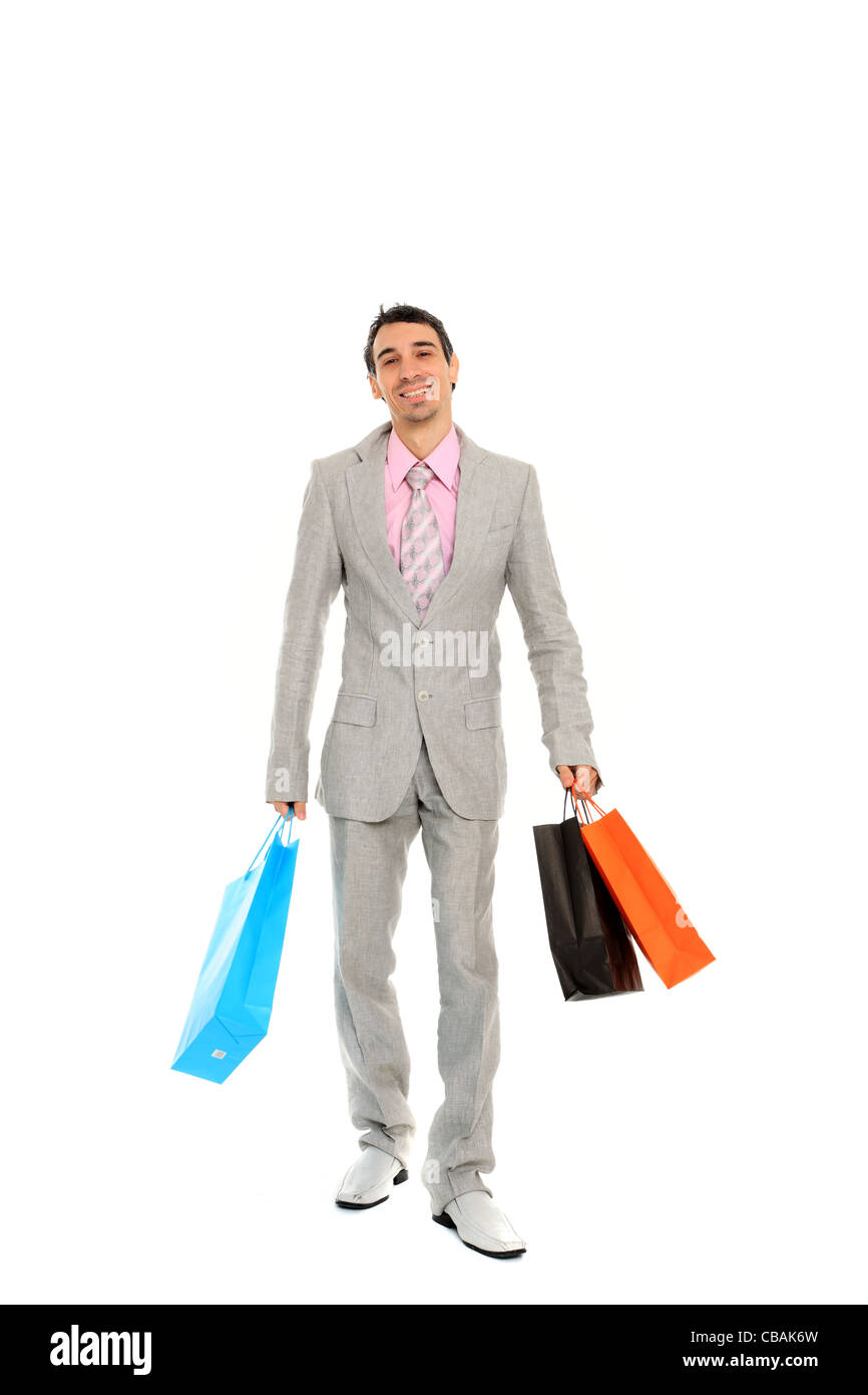 Happy shopping man. Isolated over white background Stock Photo - Alamy