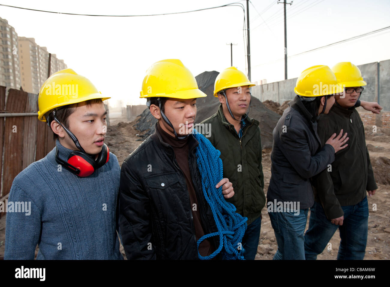 Construction workers walking at a construction site Stock Photo - Alamy