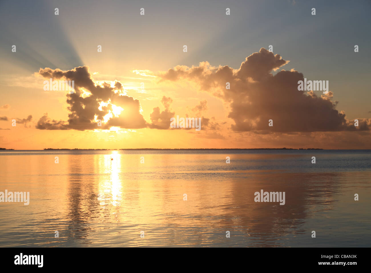 Sunset with Sunbeams at Manihi Atoll in the South Pacific with Coconut ...
