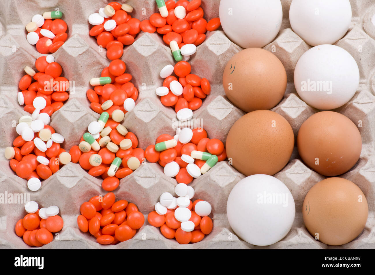 object on white - egg and medical tablet on box Stock Photo - Alamy