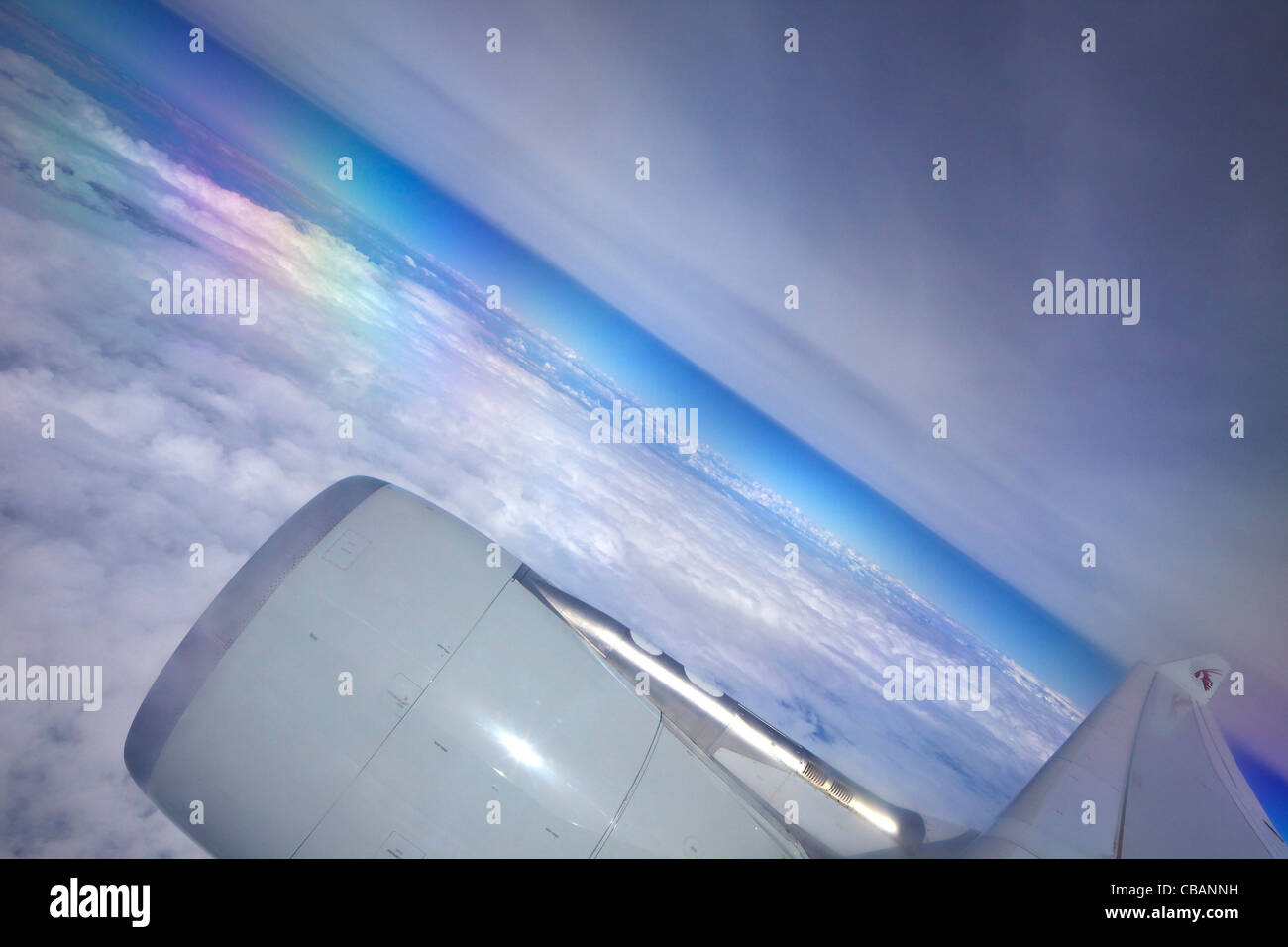 View through passenger jet window of Qatar airliner wing, sky and ...