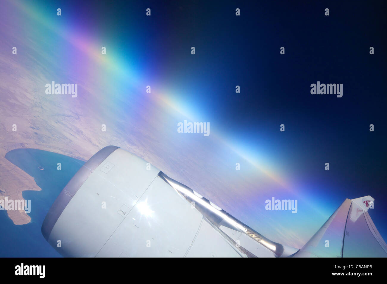 View through passenger jet window of Qatar airliner wing, sky and ...