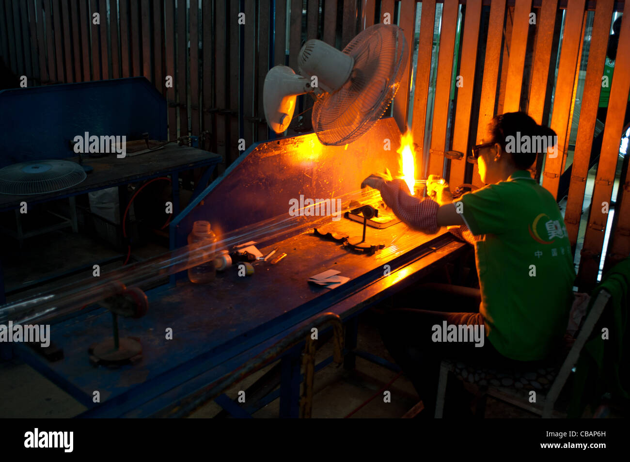 A worker in the Himin Solar Corporation, a Chinese factory leader in ...