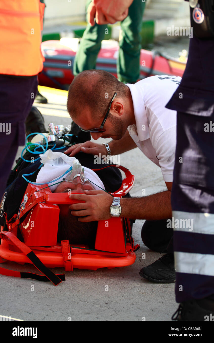 Paramedic attending an injured person Stock Photo - Alamy