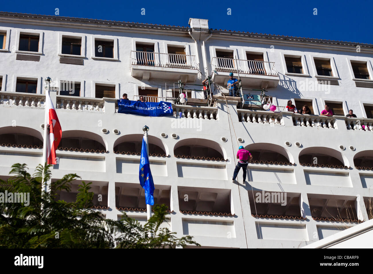 A man rappels a building for charity, Main Street, Gibraltar Stock ...