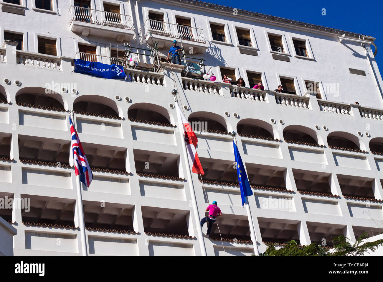 A man rappels a building for charity, Main Street, Gibraltar Stock ...