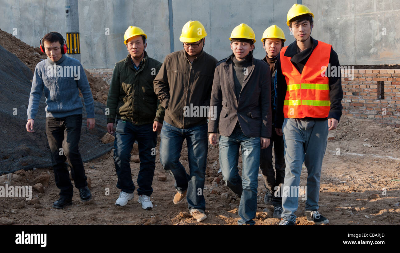 Construction workers walking at a construction site Stock Photo - Alamy