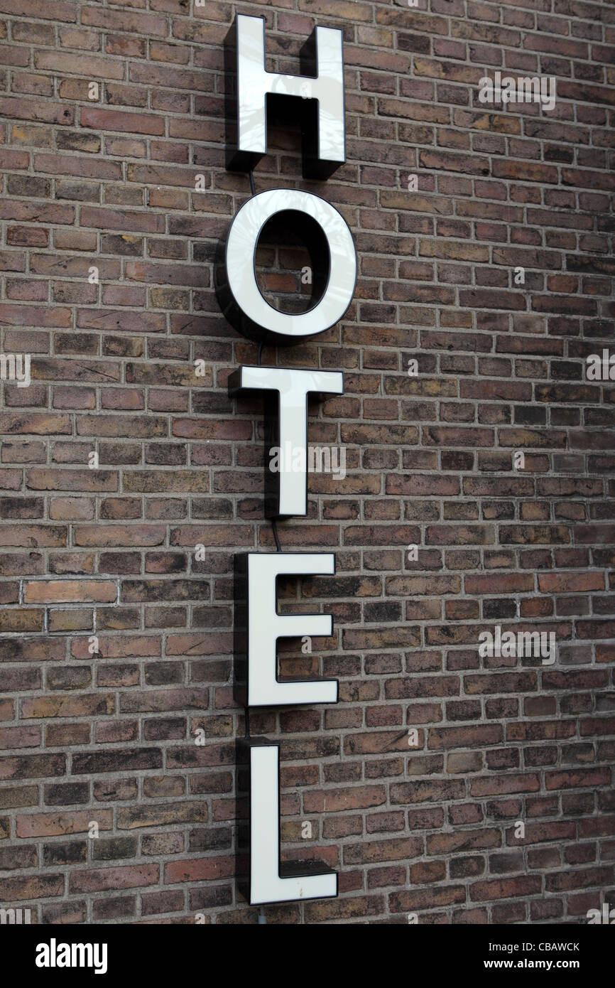 Sign for a hotel on a brick background Stock Photo - Alamy