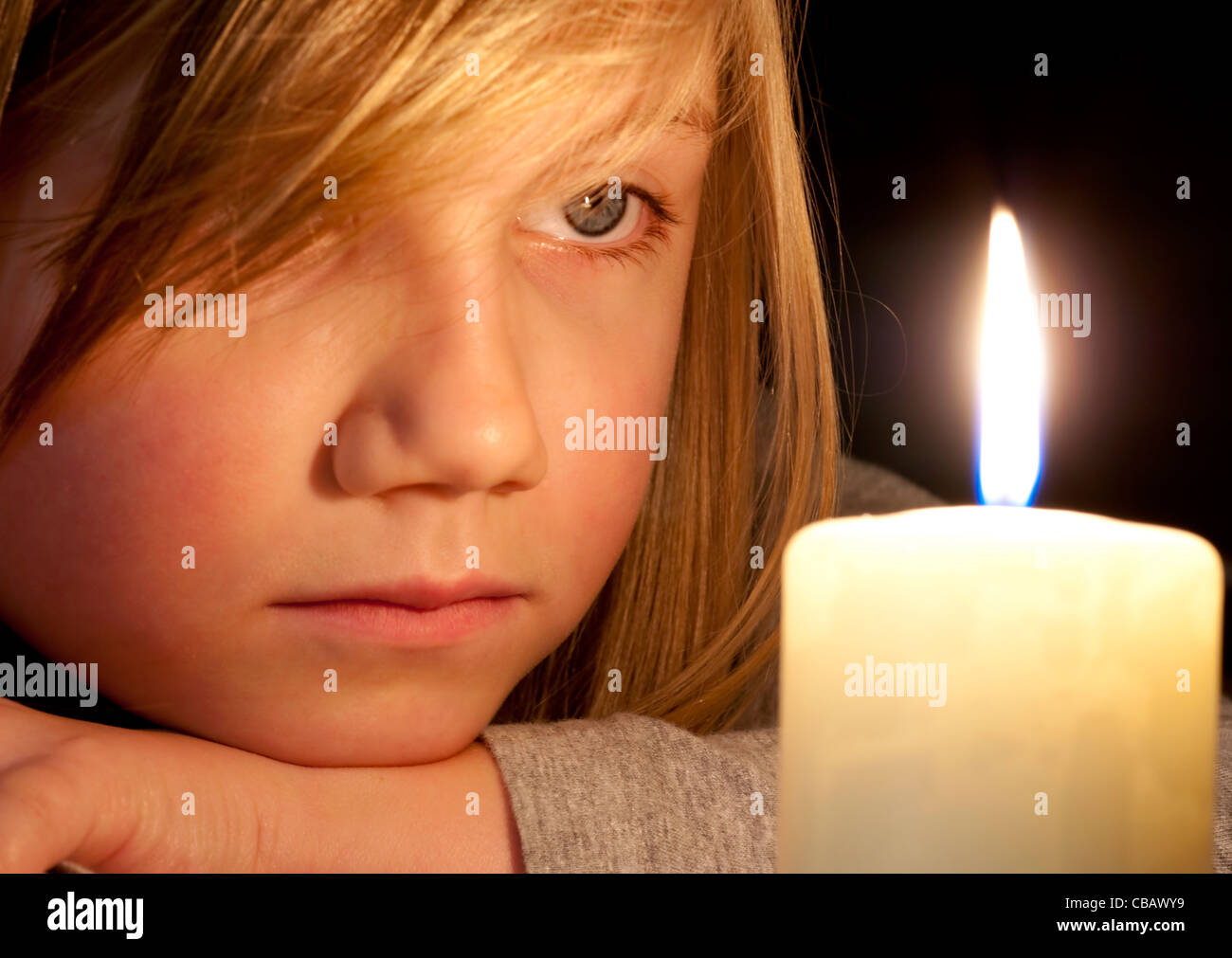 Girl lit by candle light Stock Photo - Alamy