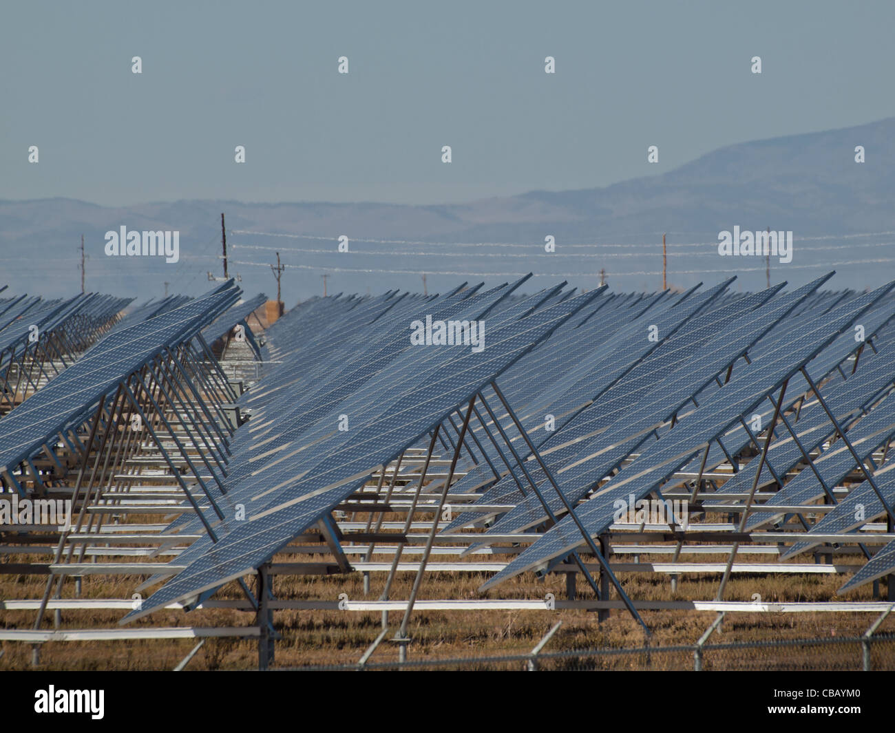A series of large solar panels forms a symmetrical line at a power ...