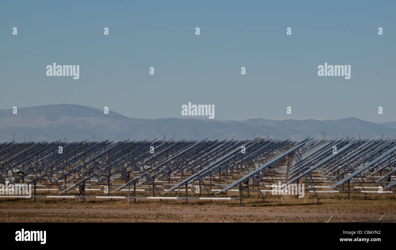 A series of large solar panels forms a symmetrical line at a power ...