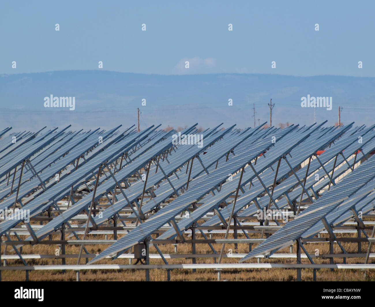 A series of large solar panels forms a symmetrical line at a power ...