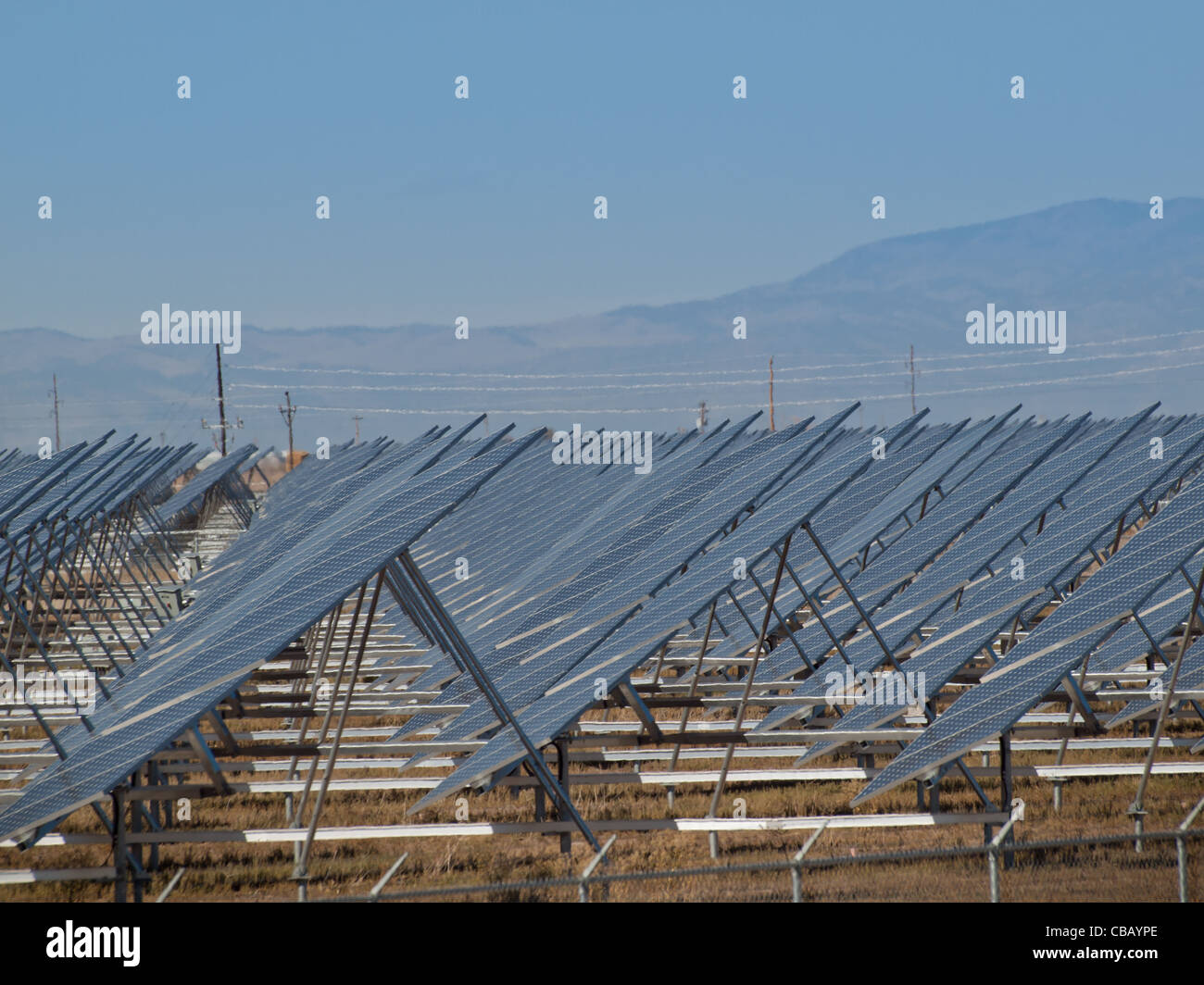 A series of large solar panels forms a symmetrical line at a power ...