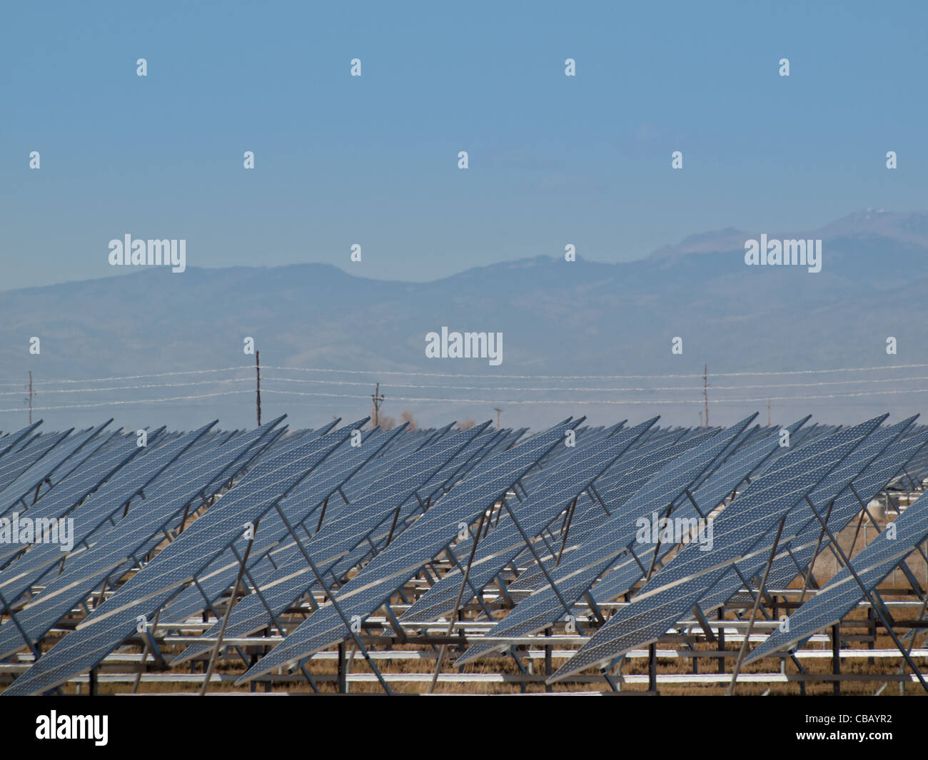 A series of large solar panels forms a symmetrical line at a power ...