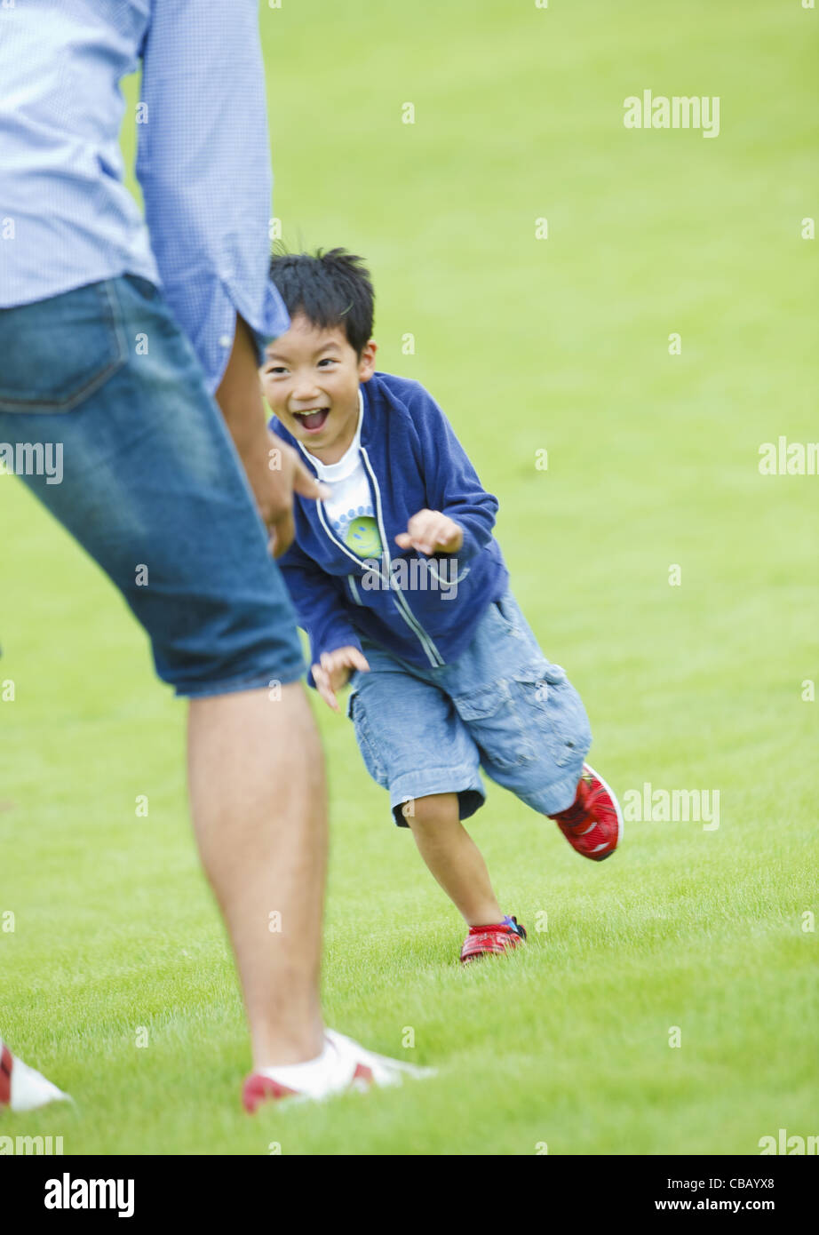 Father and son playing on grass Stock Photo - Alamy