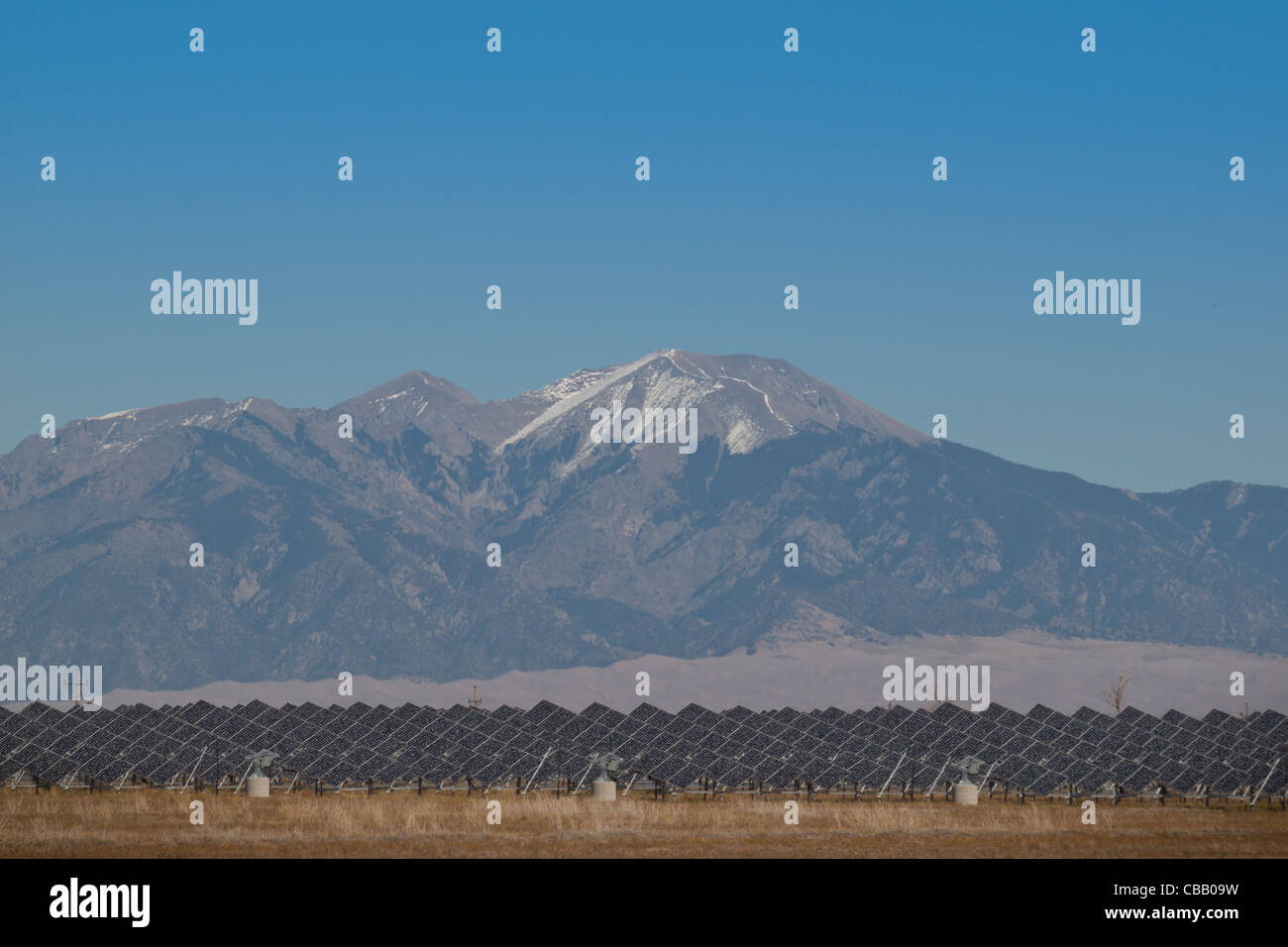 A series of large solar panels forms a symmetrical line at a power ...