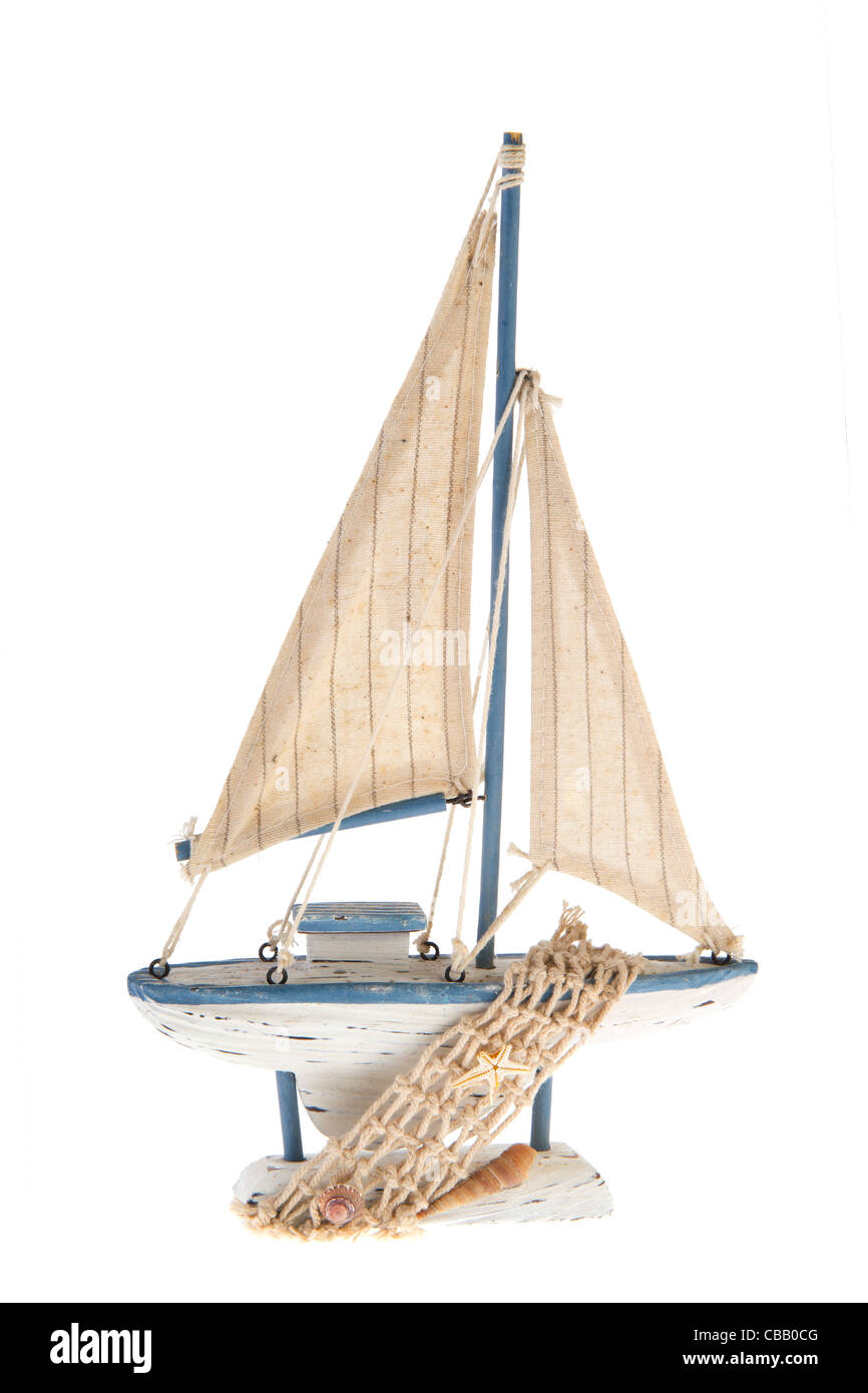 Old white and blue miniature sailboat Stock Photo - Alamy