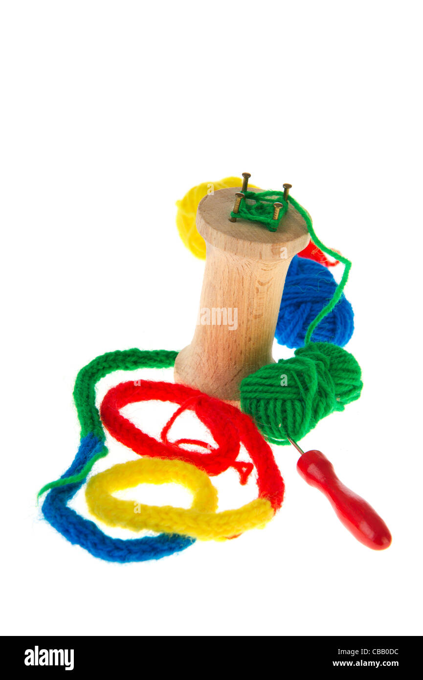 Spool knitting with colorful wool Stock Photo - Alamy