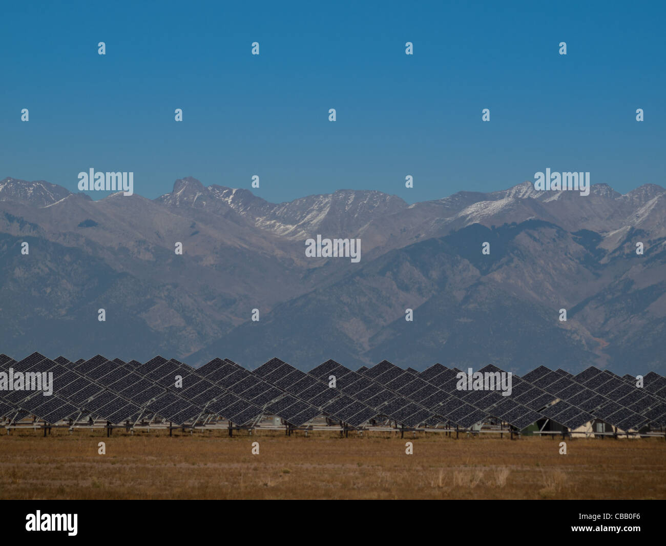 A series of large solar panels forms a symmetrical line at a power ...