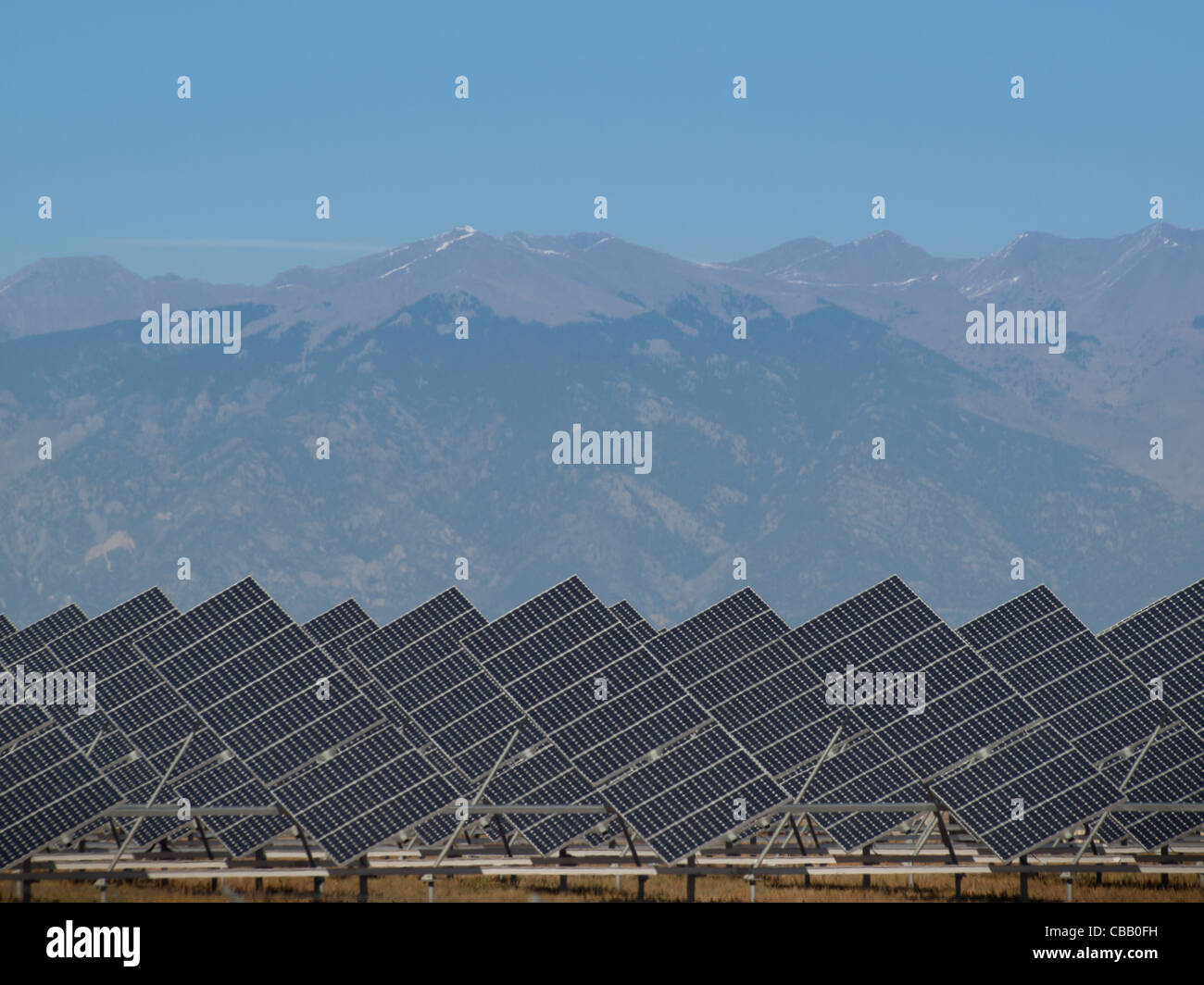 A series of large solar panels forms a symmetrical line at a power ...