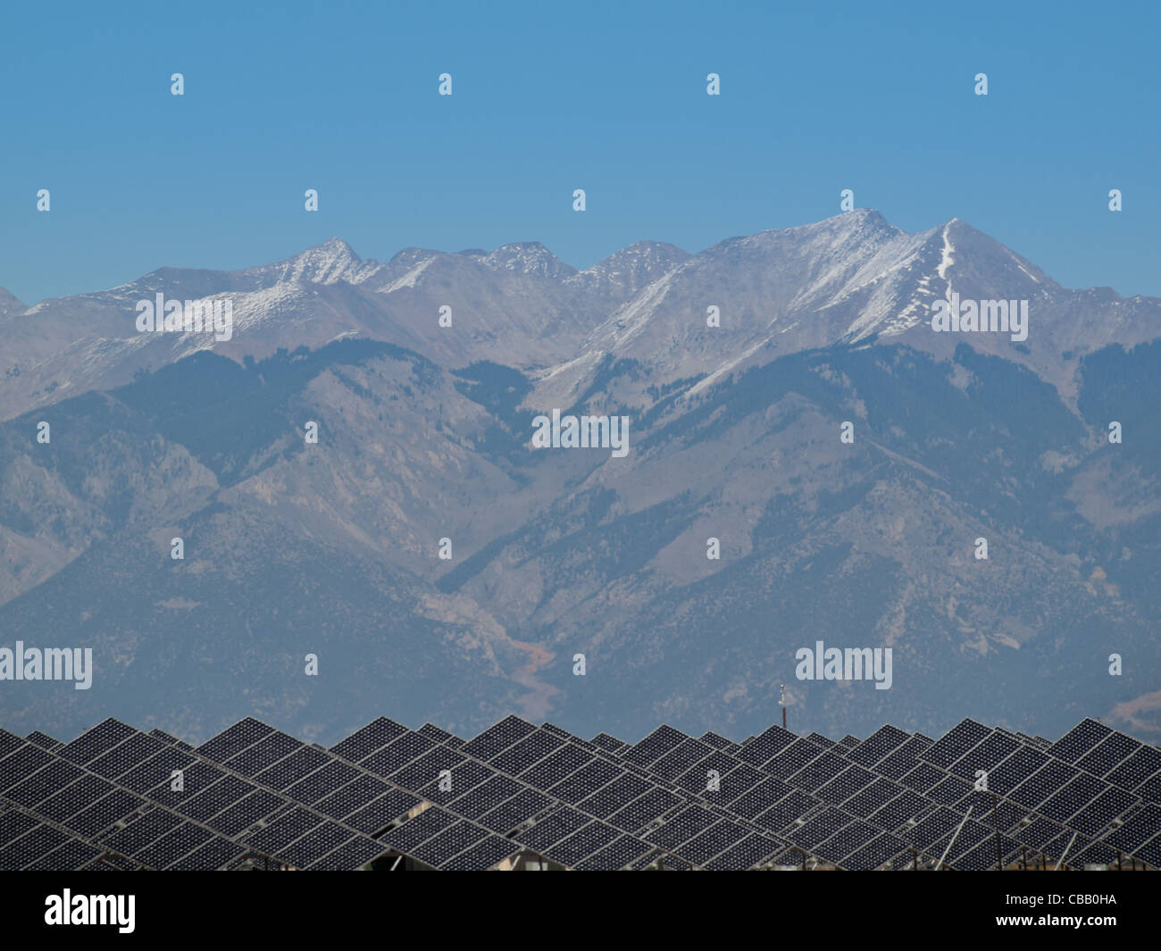 A series of large solar panels forms a symmetrical line at a power ...