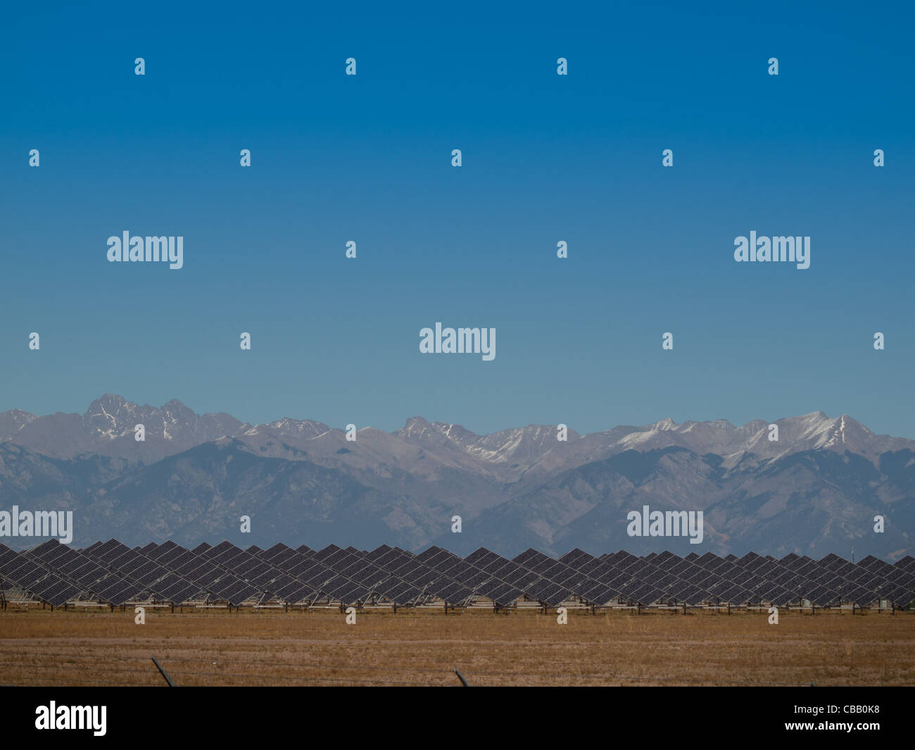 A series of large solar panels forms a symmetrical line at a power ...