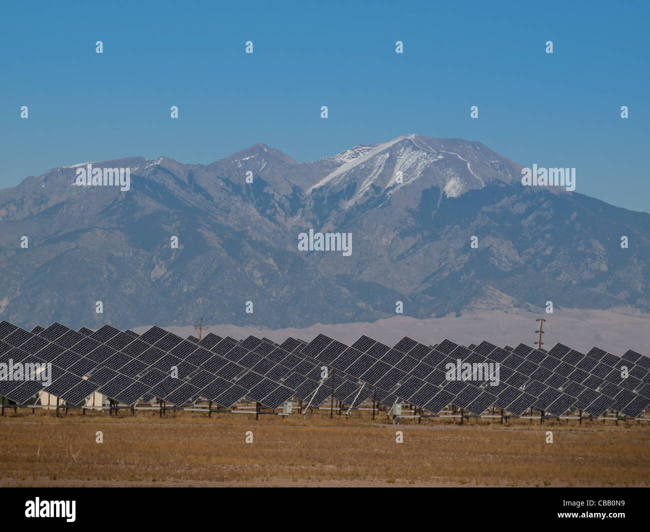 A series of large solar panels forms a symmetrical line at a power ...