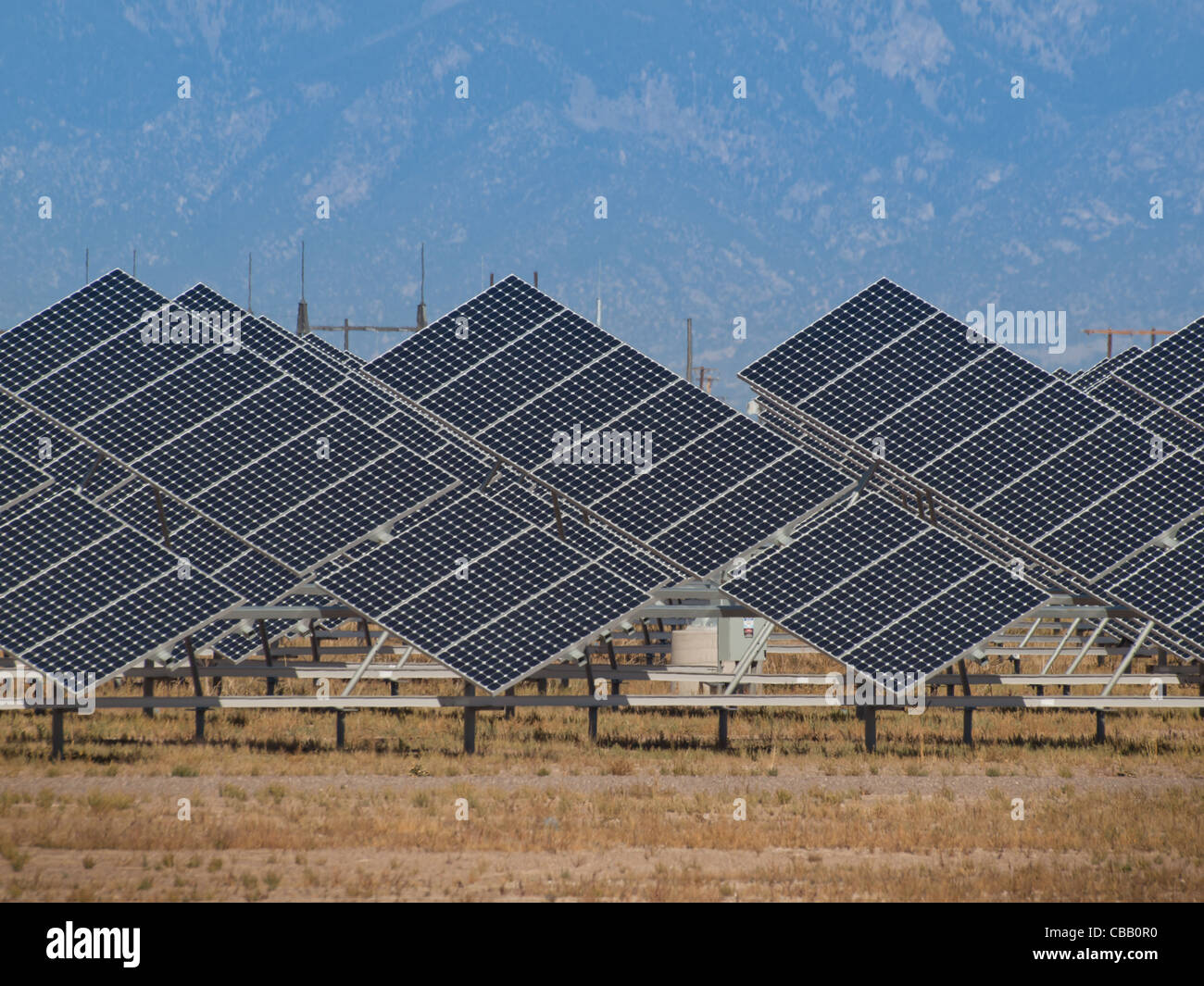 A series of large solar panels forms a symmetrical line at a power ...