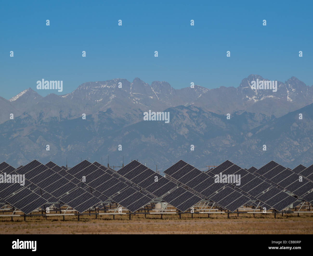 A series of large solar panels forms a symmetrical line at a power ...