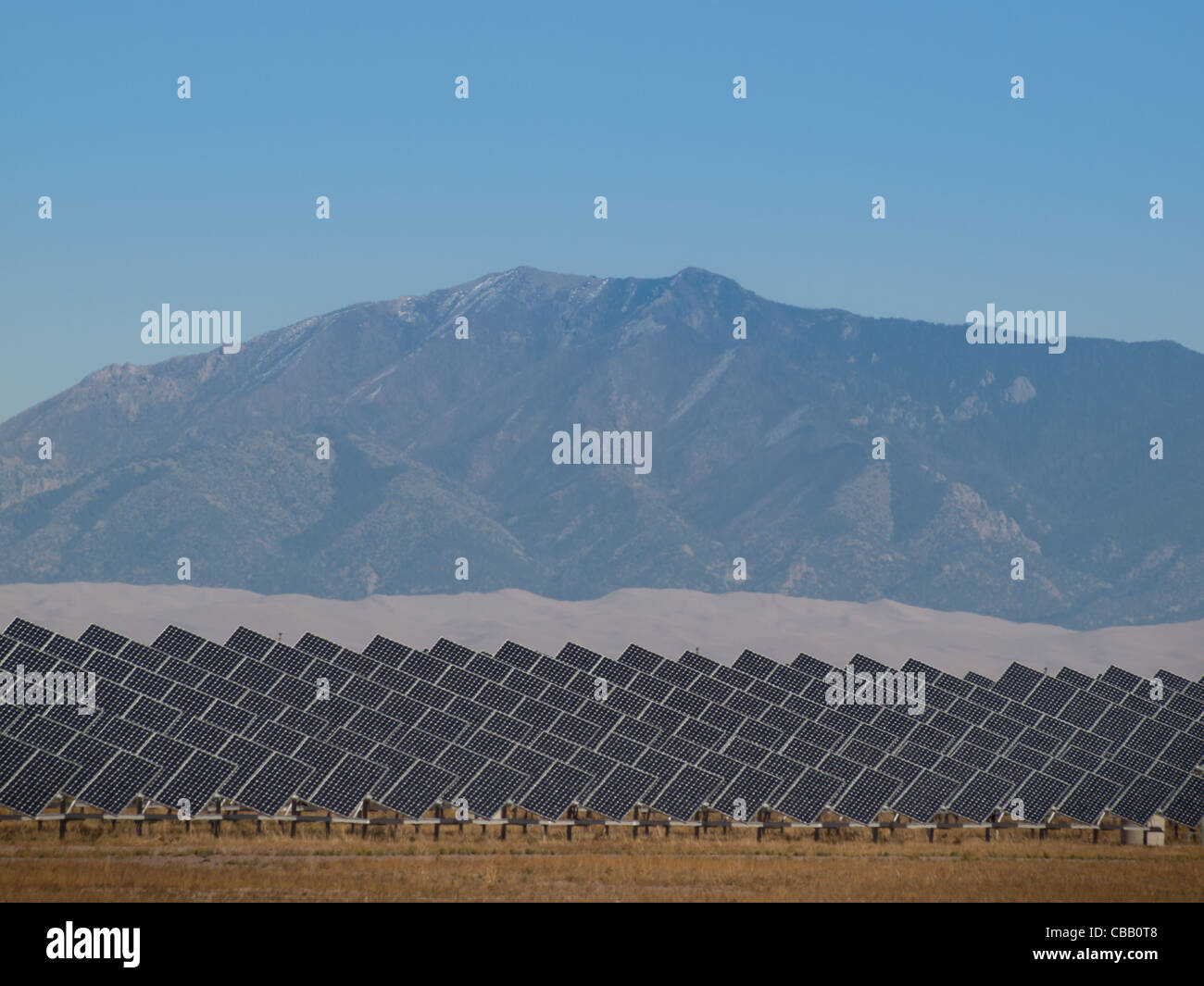 A series of large solar panels forms a symmetrical line at a power ...