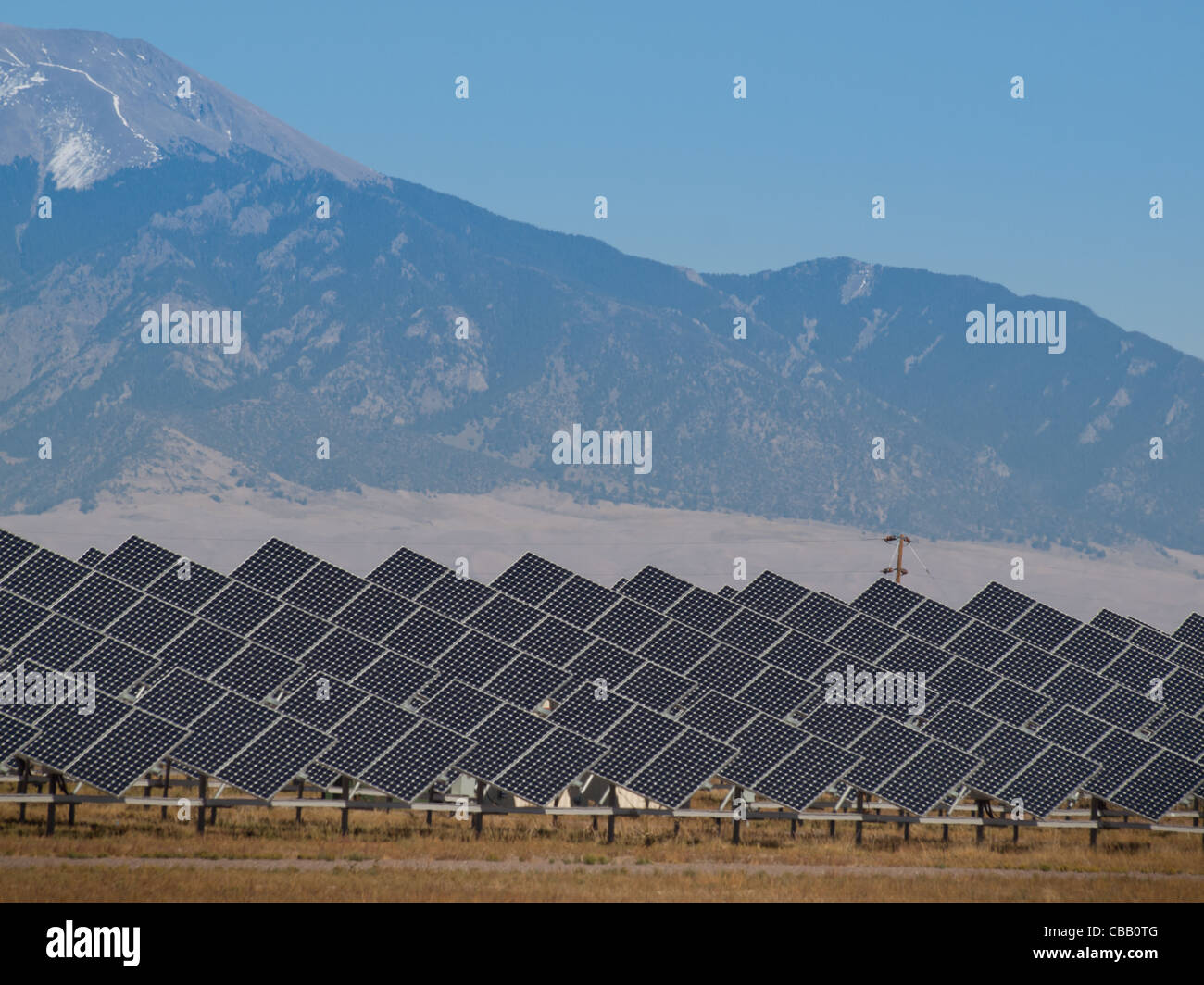 A series of large solar panels forms a symmetrical line at a power ...
